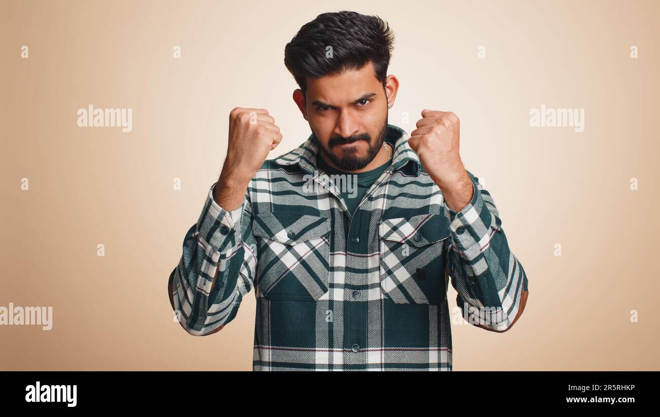 Aggressive angry young indian man trying to fight at camera, shaking ...
