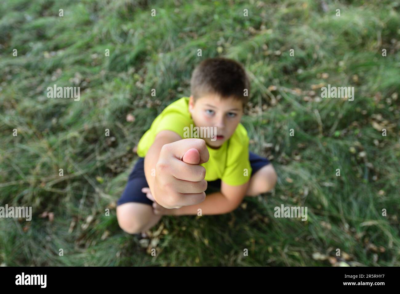 Teen boy shows the hand gesture Stock Photo - Alamy