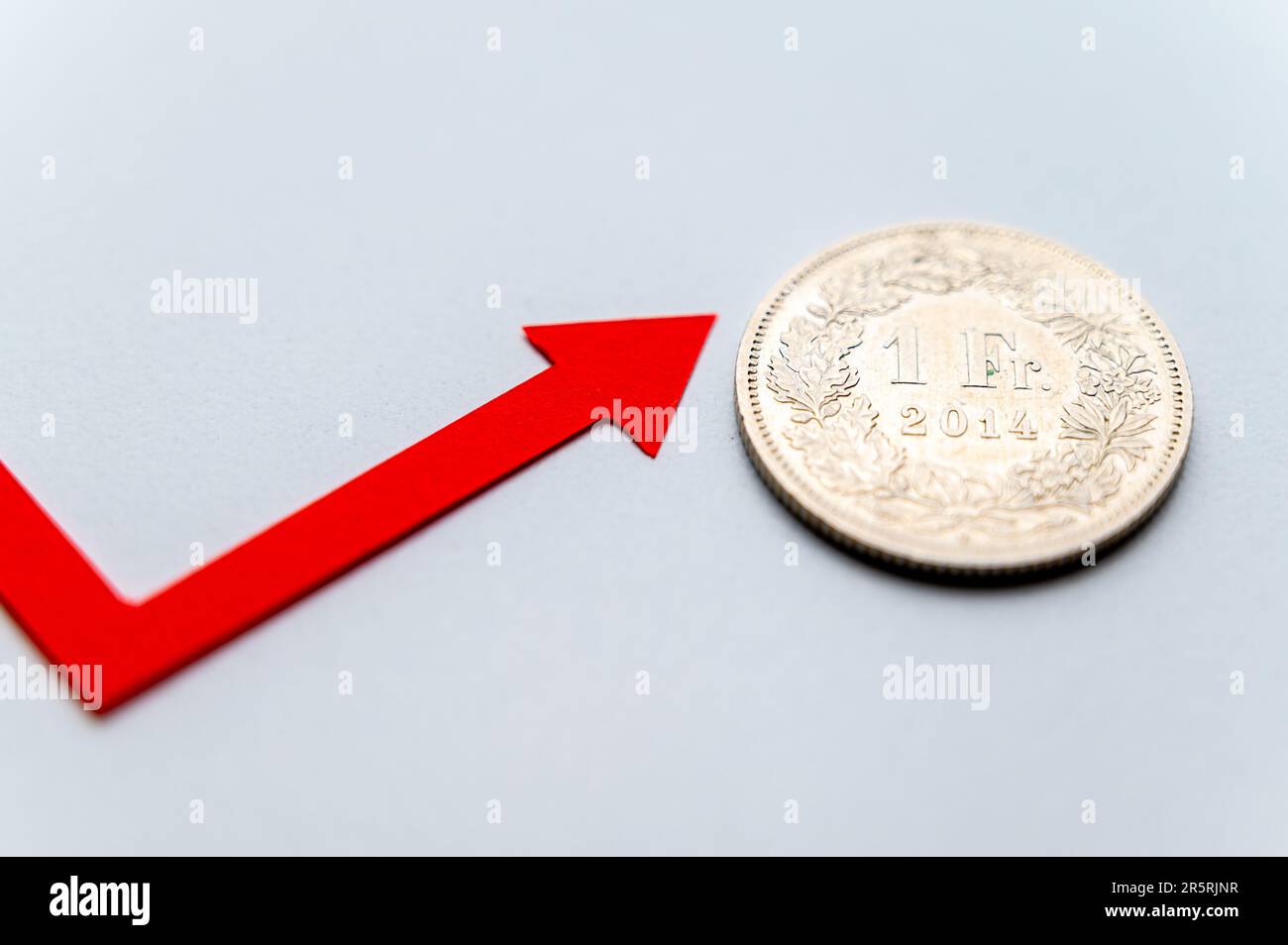 1 Swiss Franc coin, next to growing line. Valuation of the Swiss Franc ...