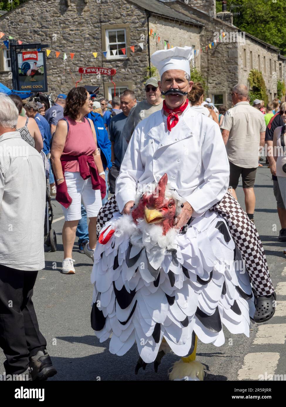 A man dressed up to look like he is riding a chicken at the Cuckoo ...
