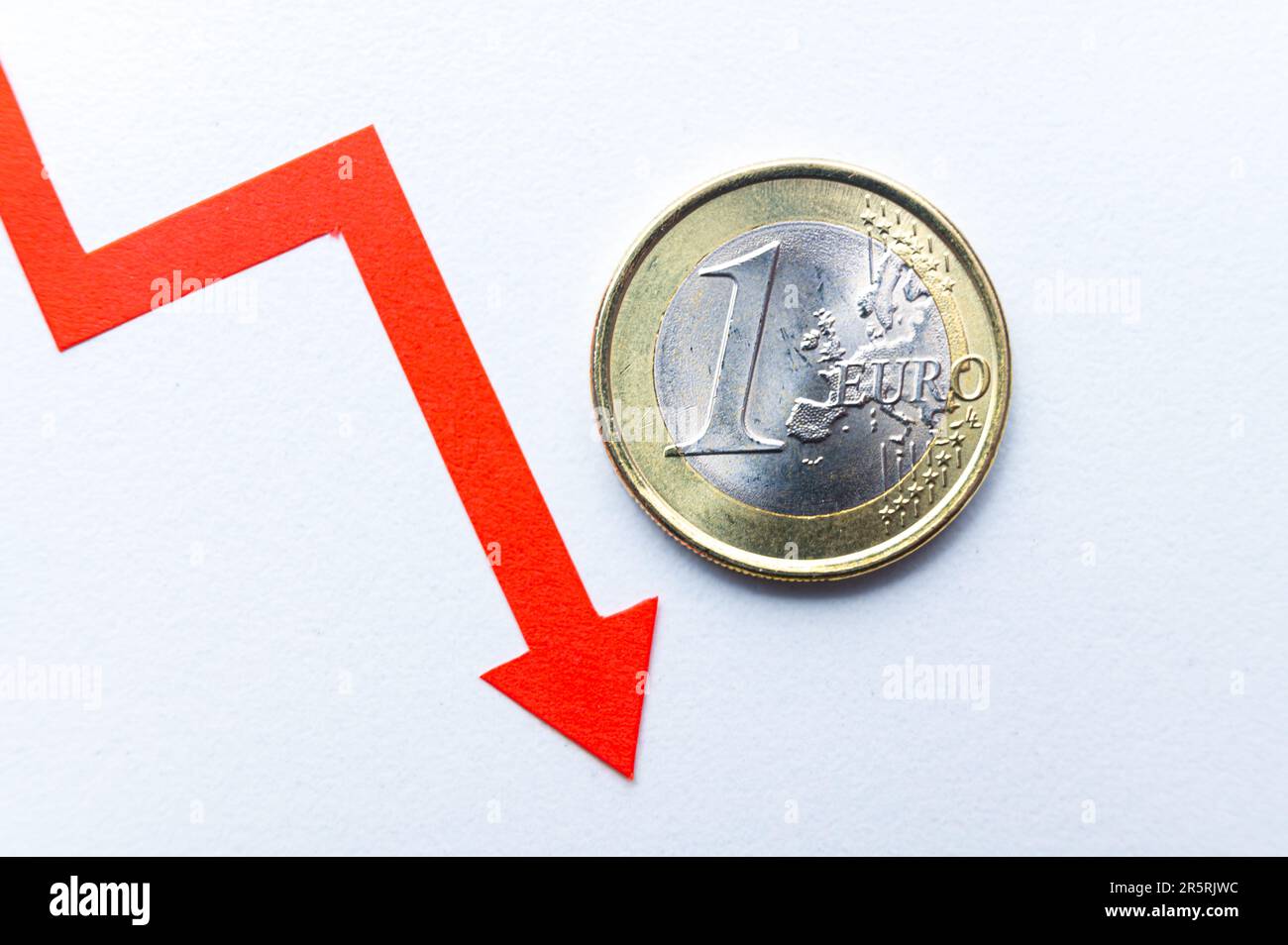 1 Euro coin, next to descending line. Valuation of the Euro and falling ...
