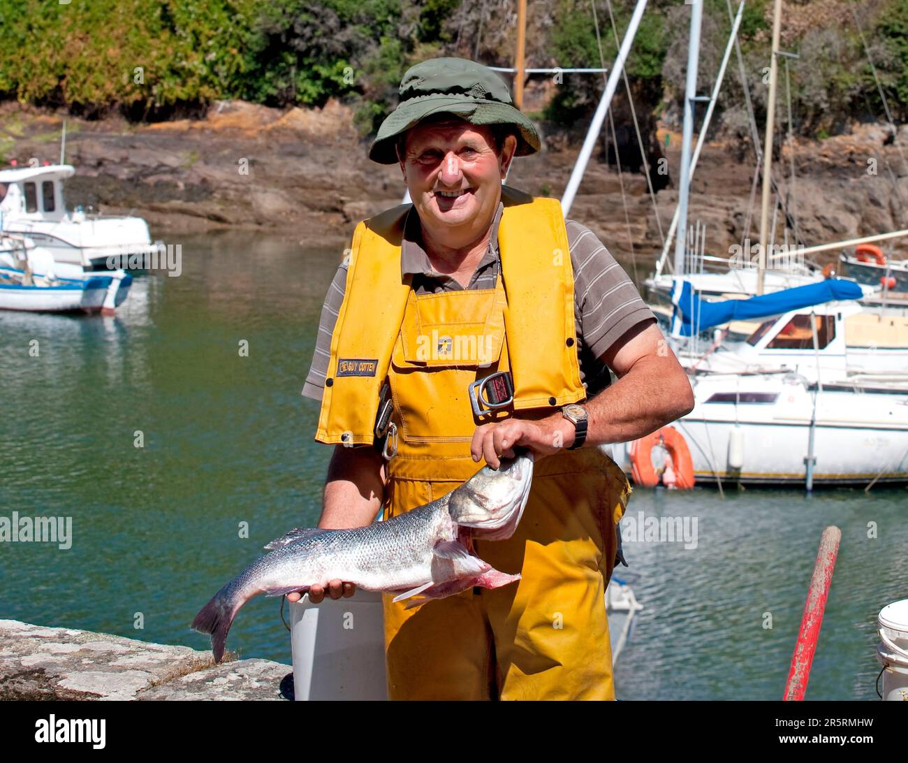 France, Finistere, Clohars Carnoet, fisherman showing his catch in ...