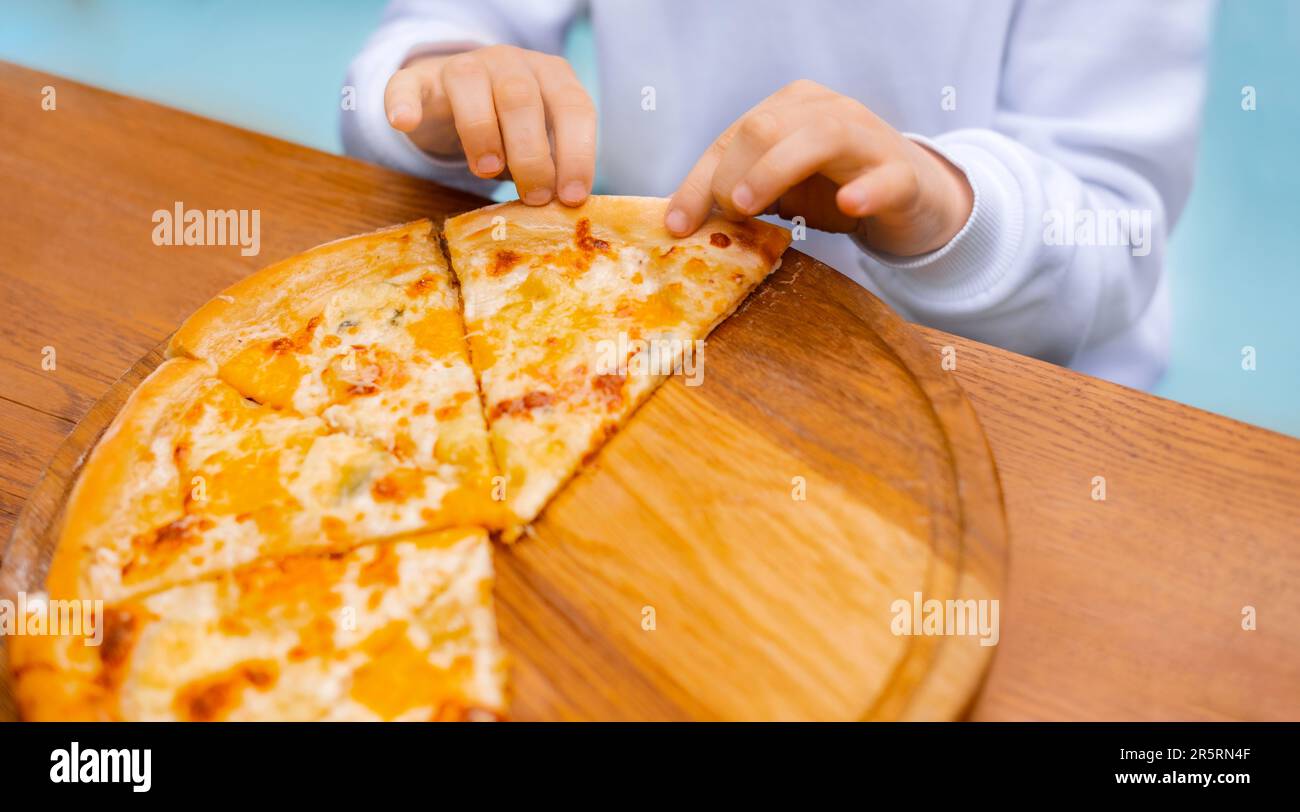 Hands take slices of pizza hi-res stock photography and images - Alamy