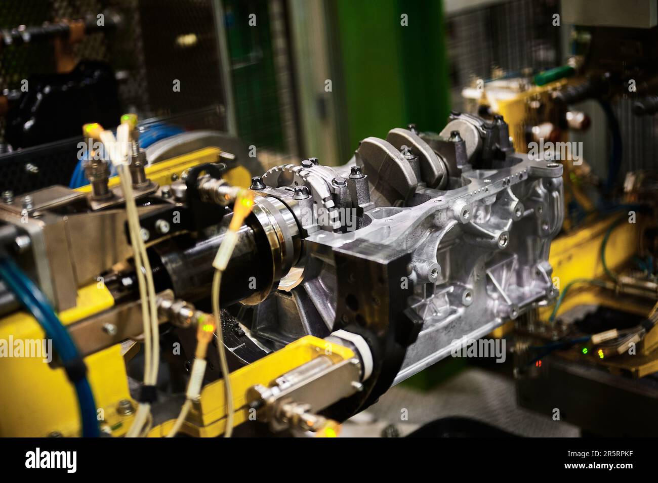 Illuminated car engine on test stand in production plant shop Stock ...