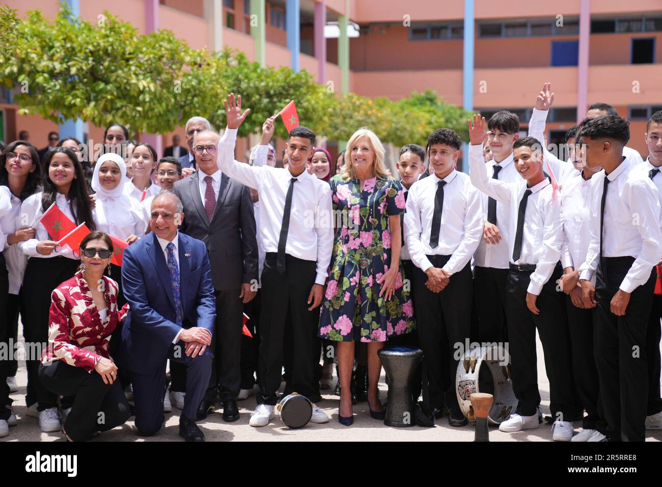 First Lady Jill Biden, center, poses for a photo with students at Ibn Al Arif high school during ...
