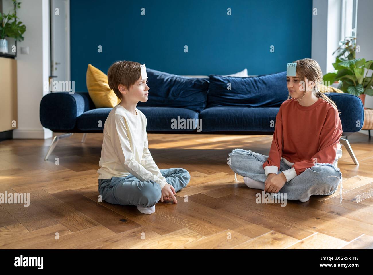 Children boy and girl siblings playing Who Am I guessing game while ...