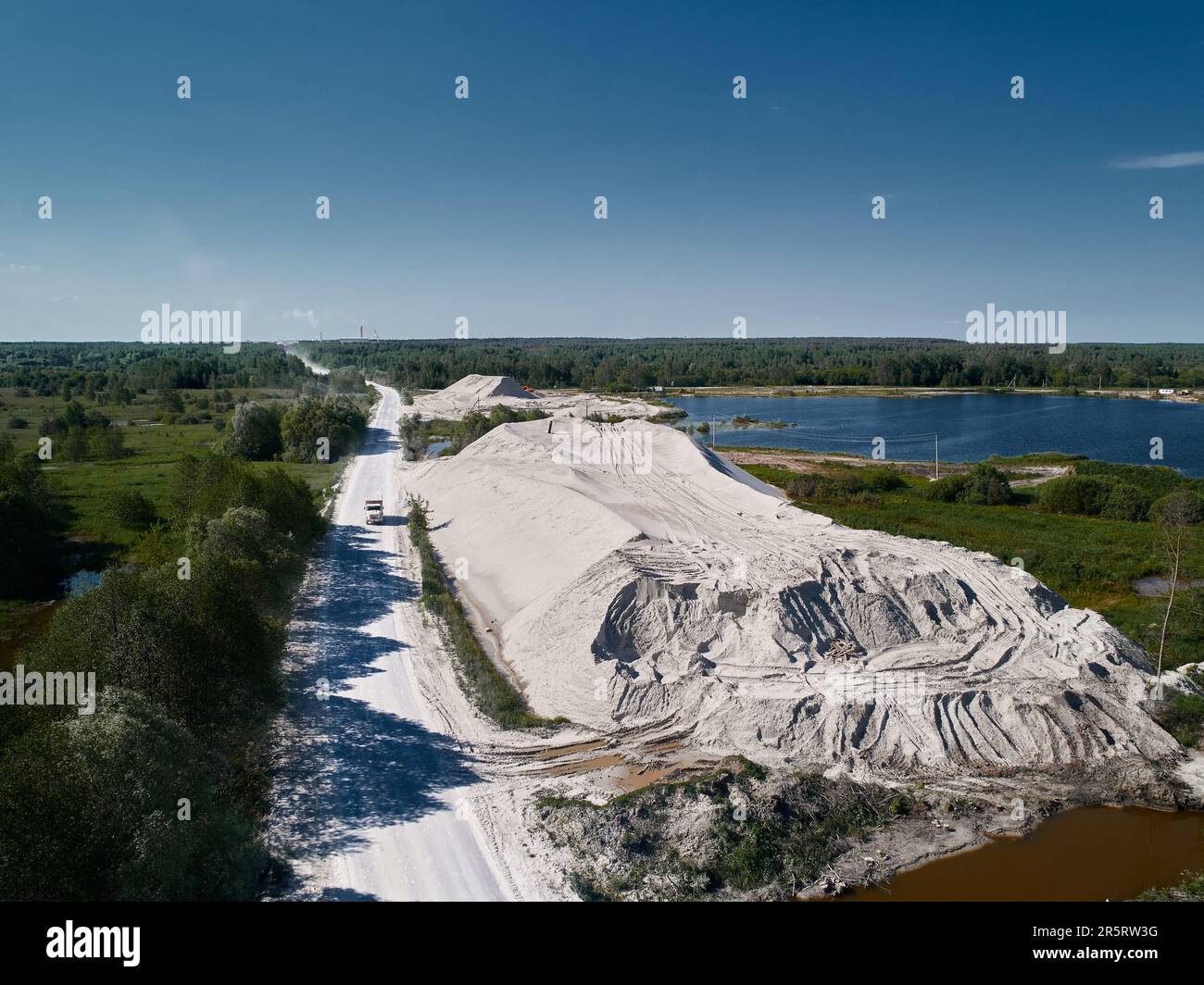Huge mound of extracted river sand near pond in open quarry Stock Photo ...