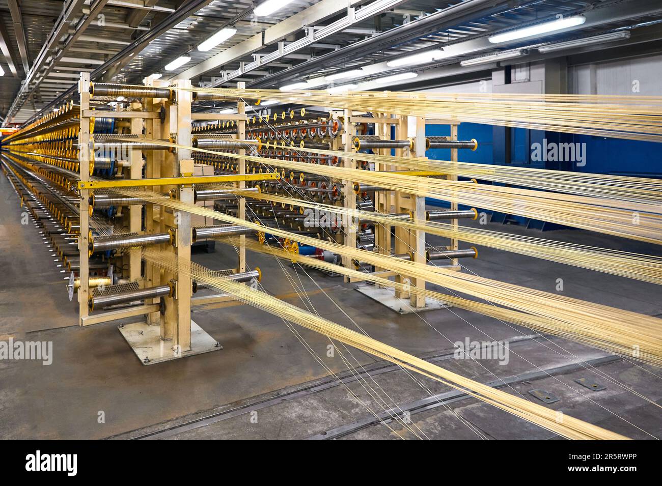 Cables for tires reinforcement in rolled steel workshop Stock Photo - Alamy
