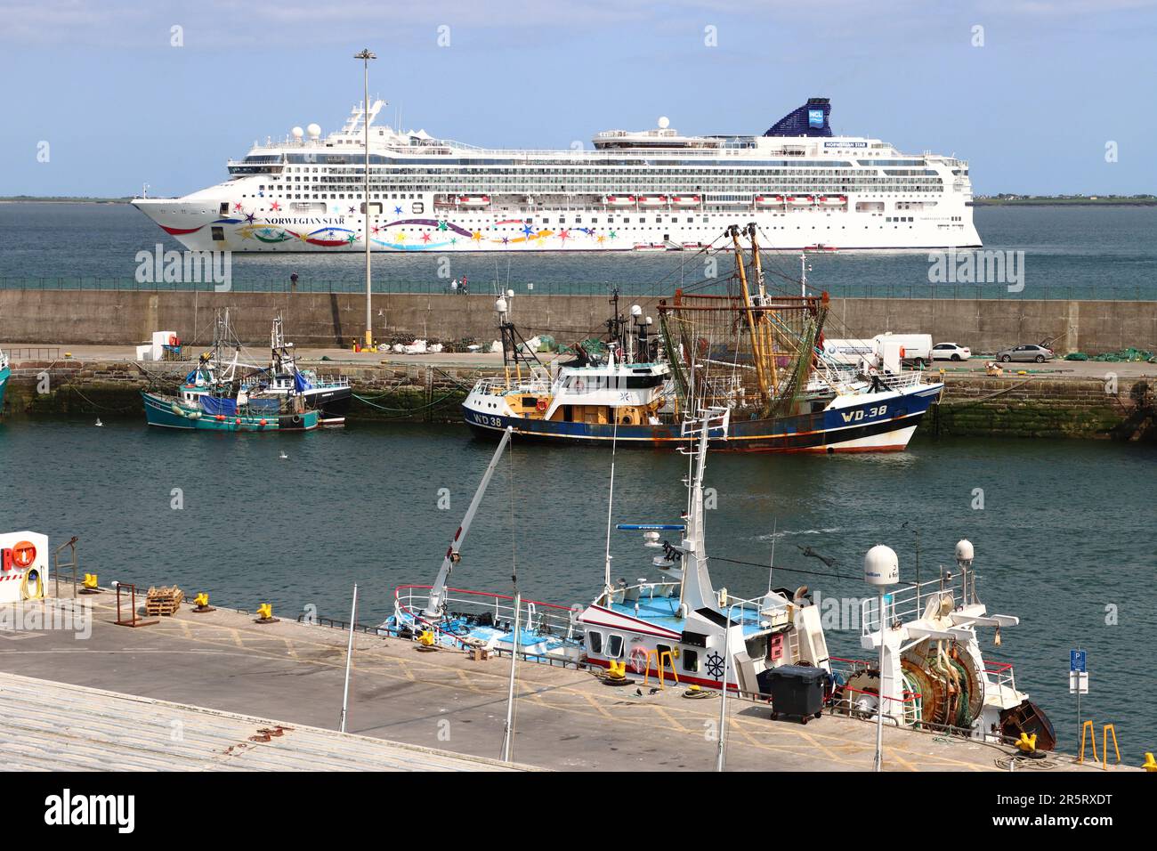 NCL Norweigian Star moored offshore and fishing vessels in the harbour at Dunmore East, County ...