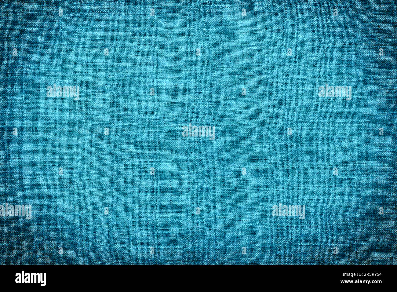 Blue linen fabric with light center and vignette for background or ...
