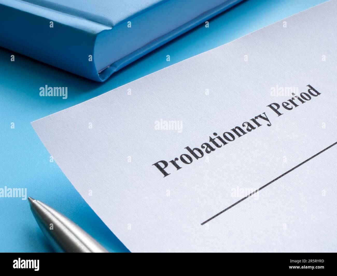 A sheet of paper with the inscription probationary period lies on the ...