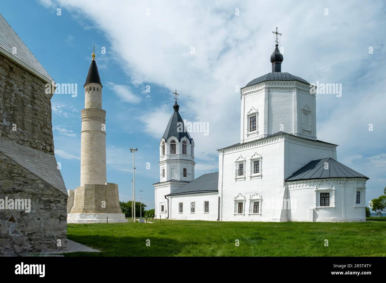 Muslim minaret of the 14th century and a later Orthodox church Stock ...