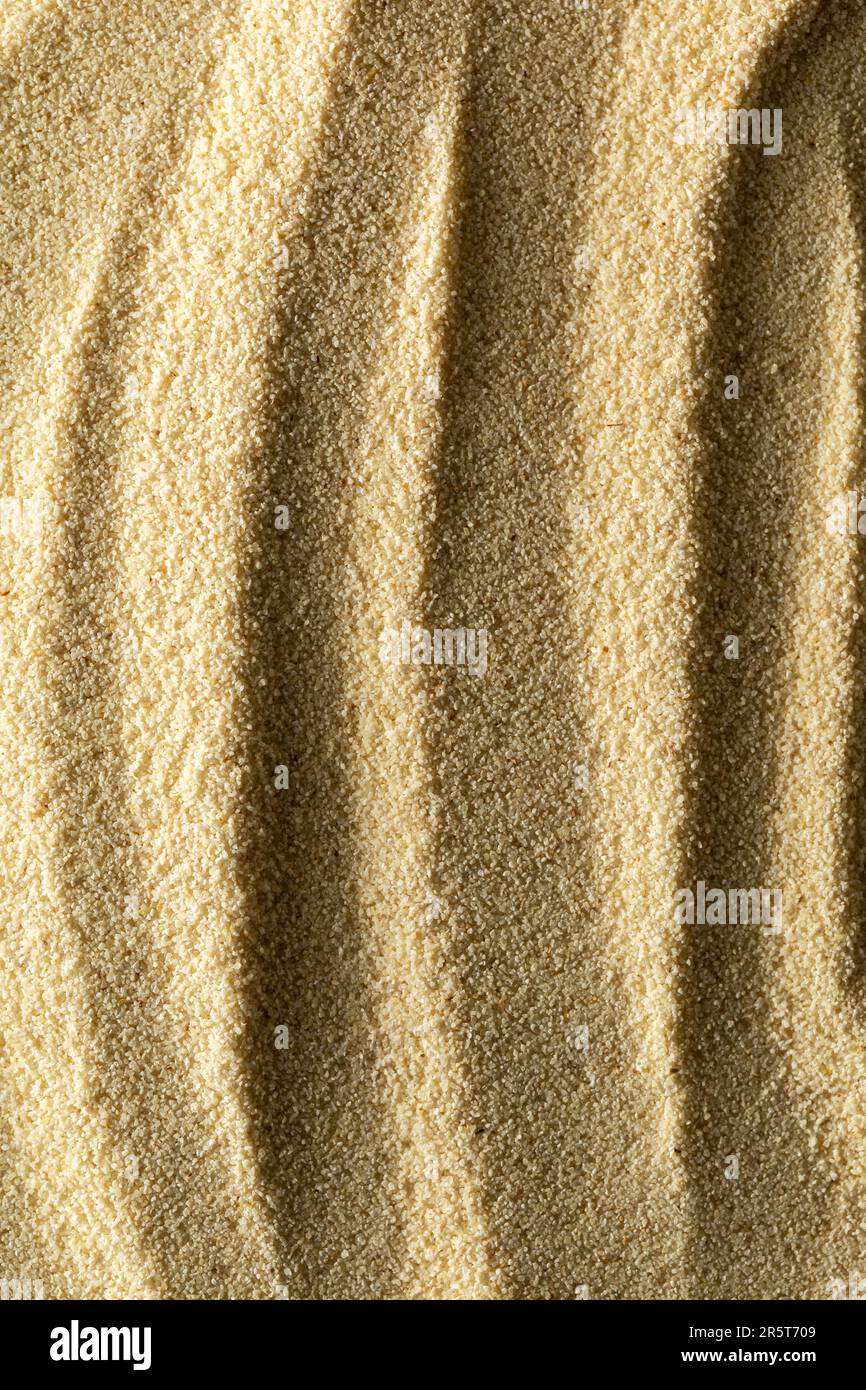 vertical sandy light background format 2:3 with waves of sand macro ...