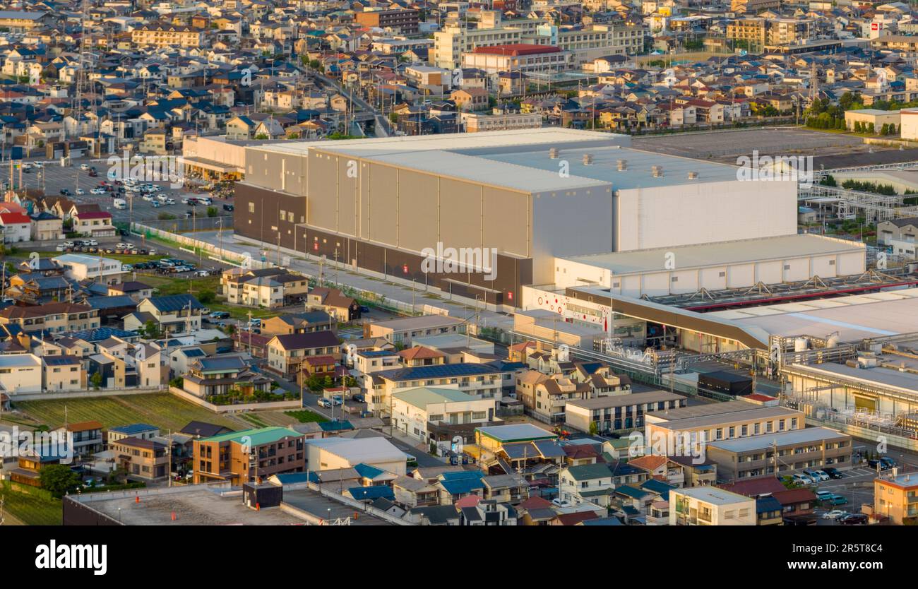 Large industrial warehouse building amid houses in residential ...