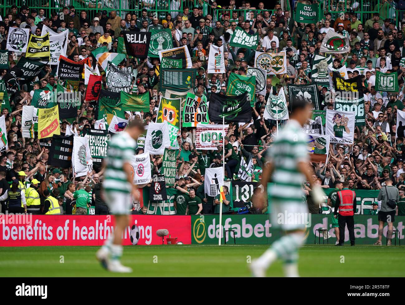 Celtic fans in the stands hold up banners during the cinch Premiership ...