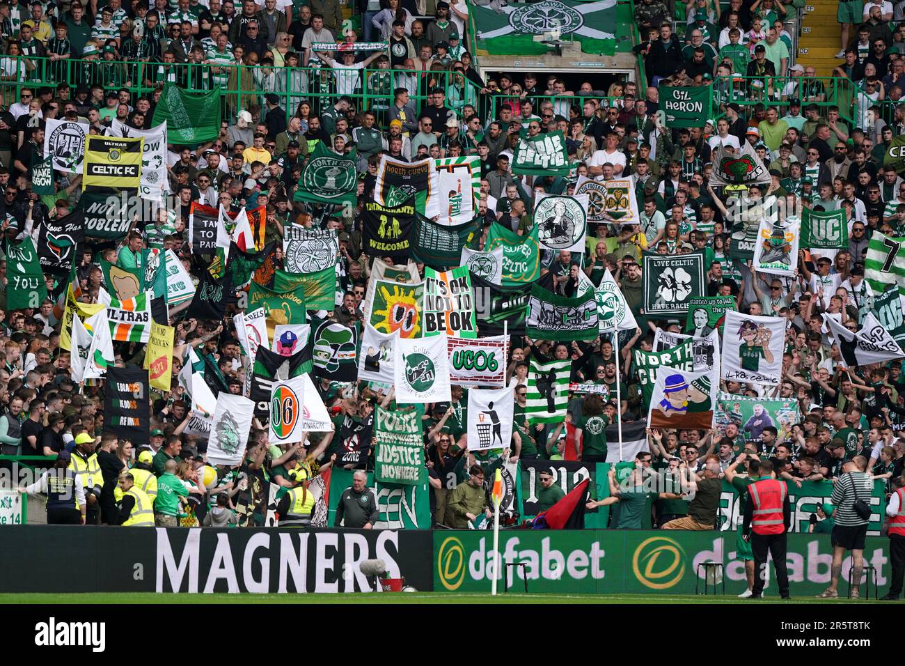 Celtic fans in the stands hold up banners during the cinch Premiership ...