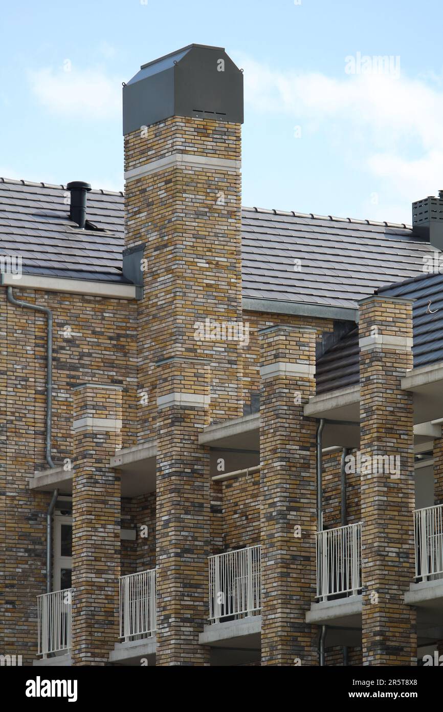 A large brick building with multiple balconies Stock Photo - Alamy
