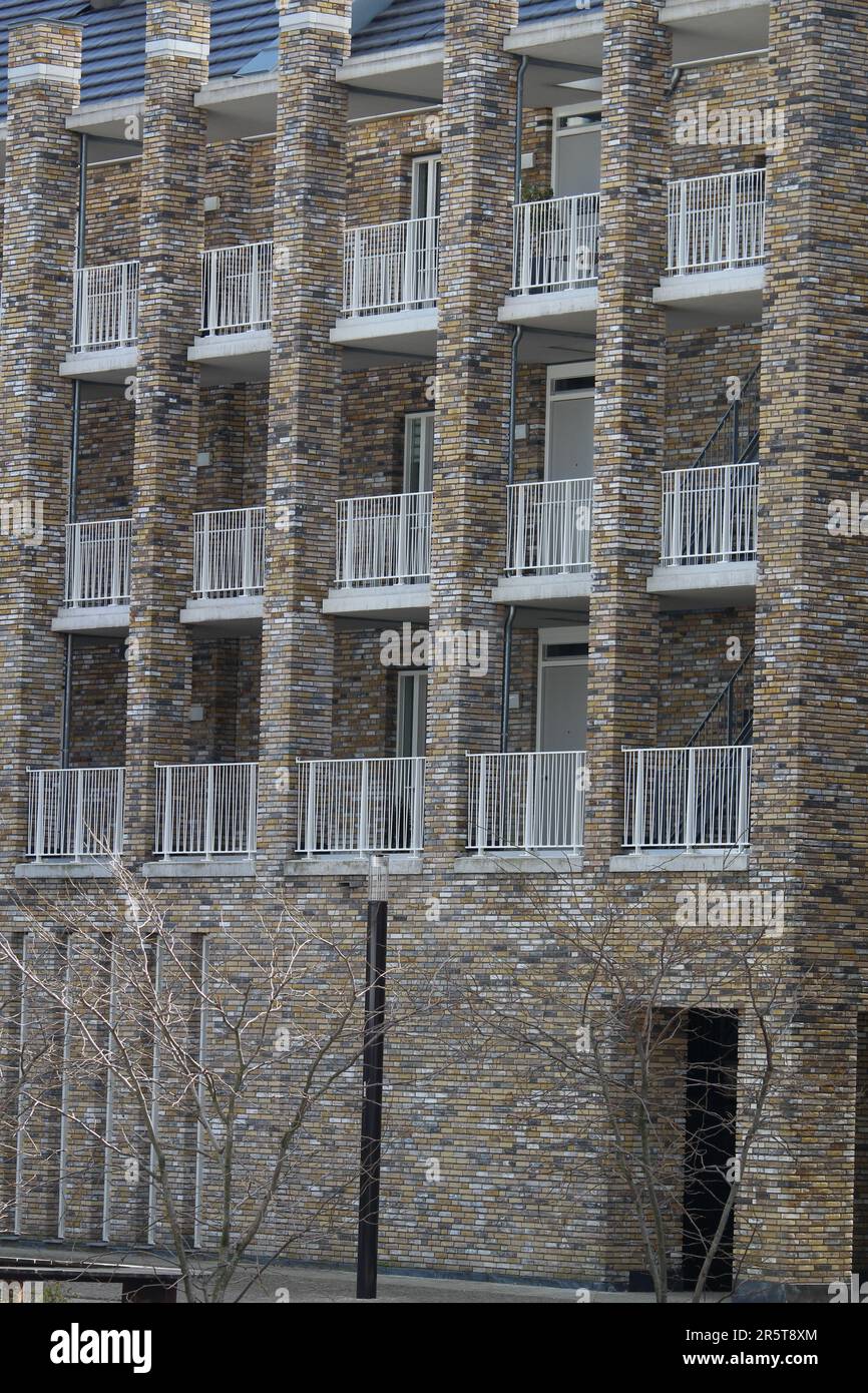 A large brick building with multiple balconies Stock Photo - Alamy