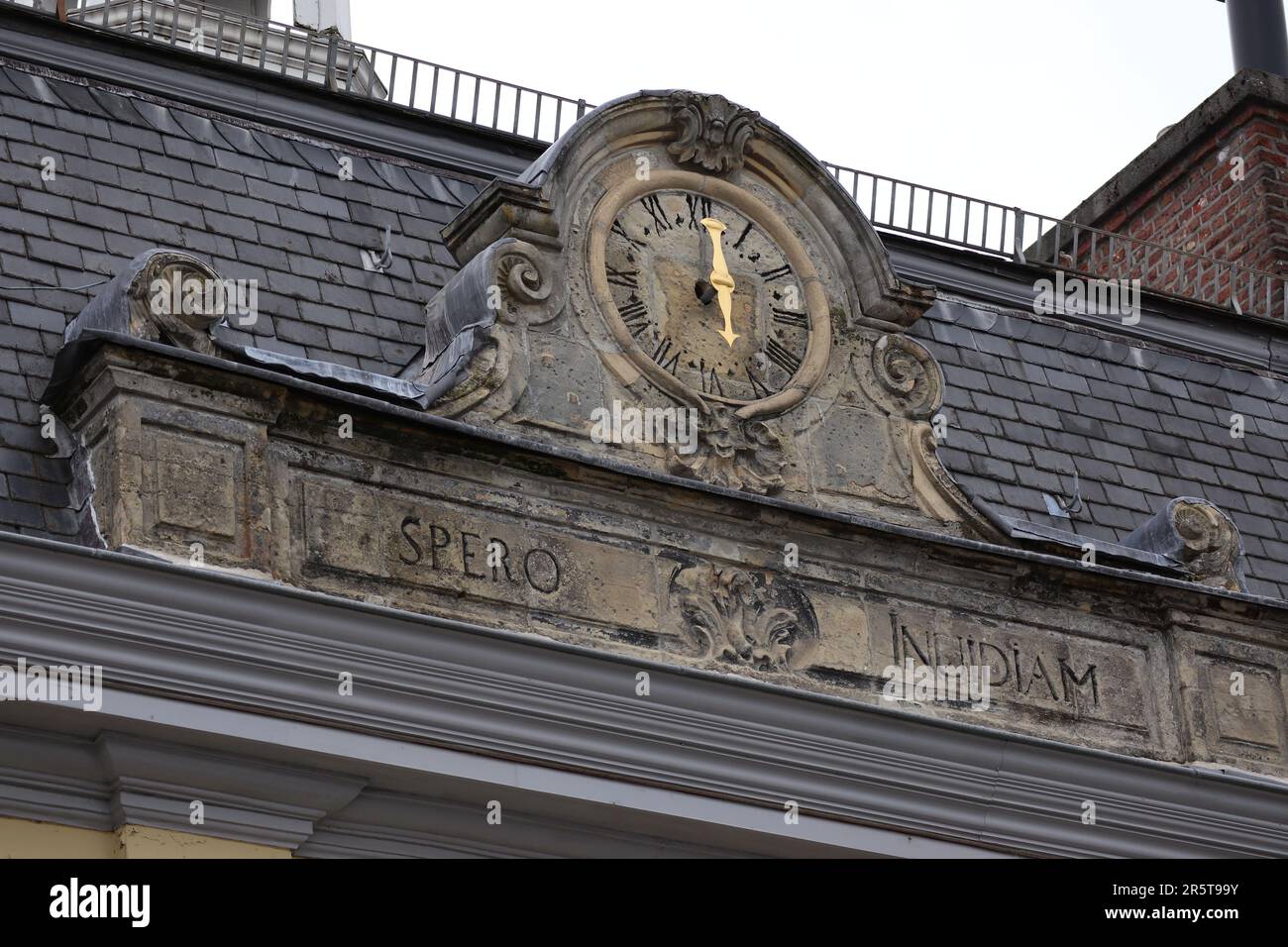 An antique-style timepiece, featuring a white face and ornate details ...