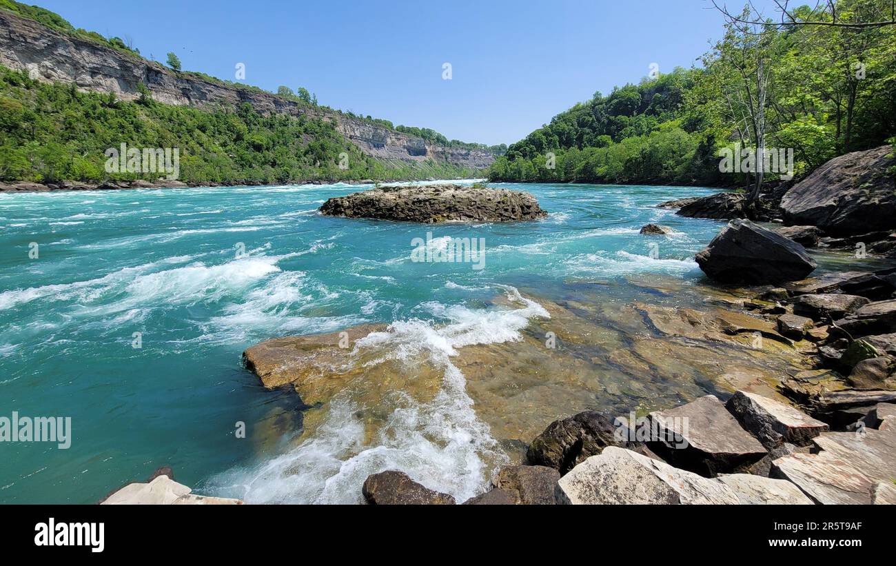 A picturesque Niagara River Rock with a powerful cascade of water ...