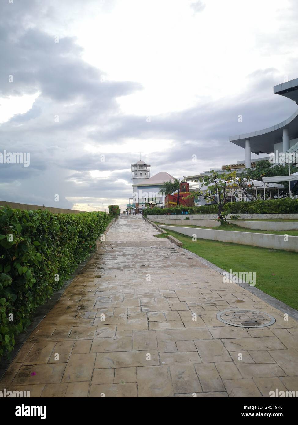 A scenic view of a pathway towards a picturesque lighthouse in the city ...