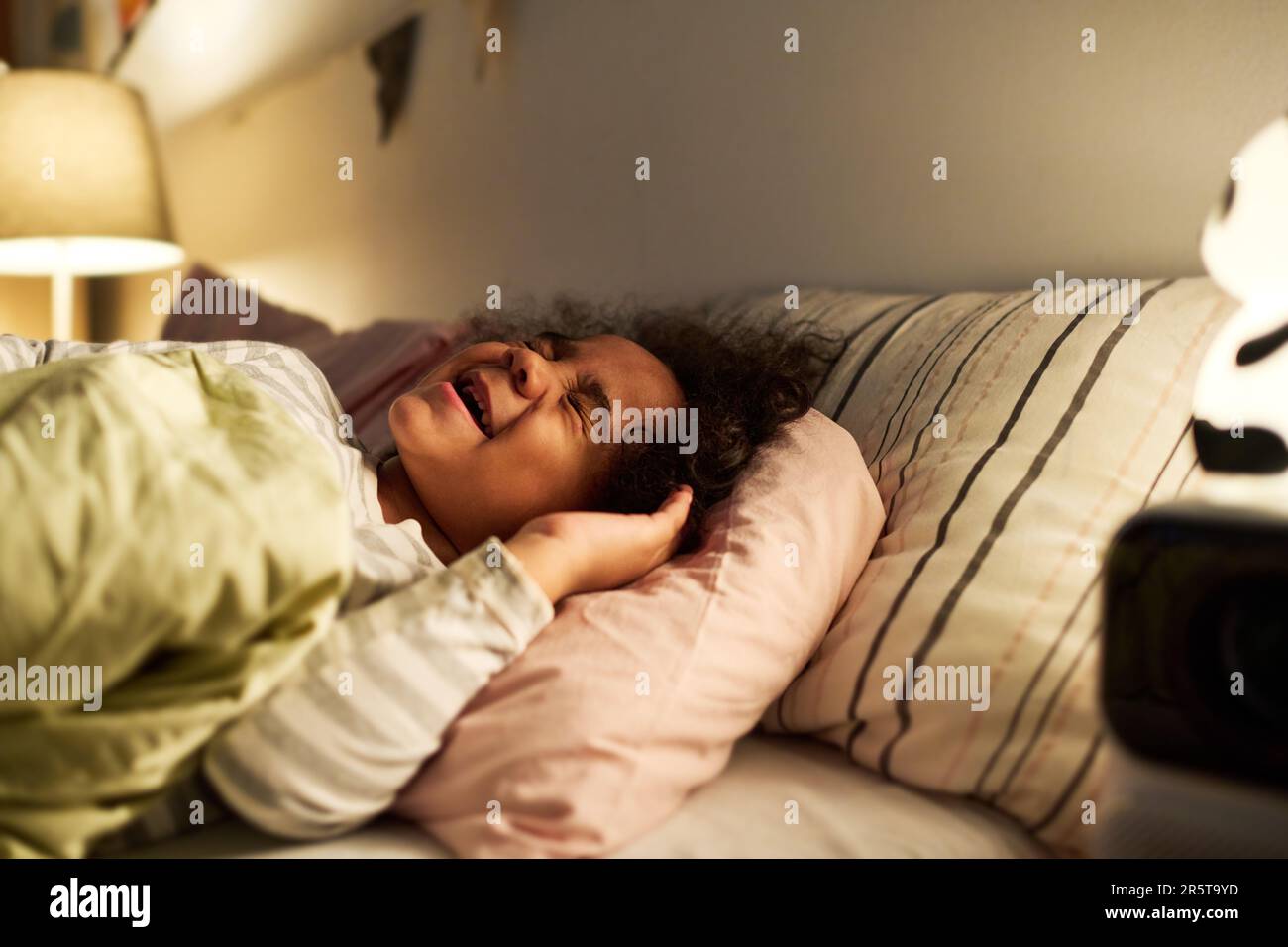 African American little boy crying in his bed, he having terrible ...