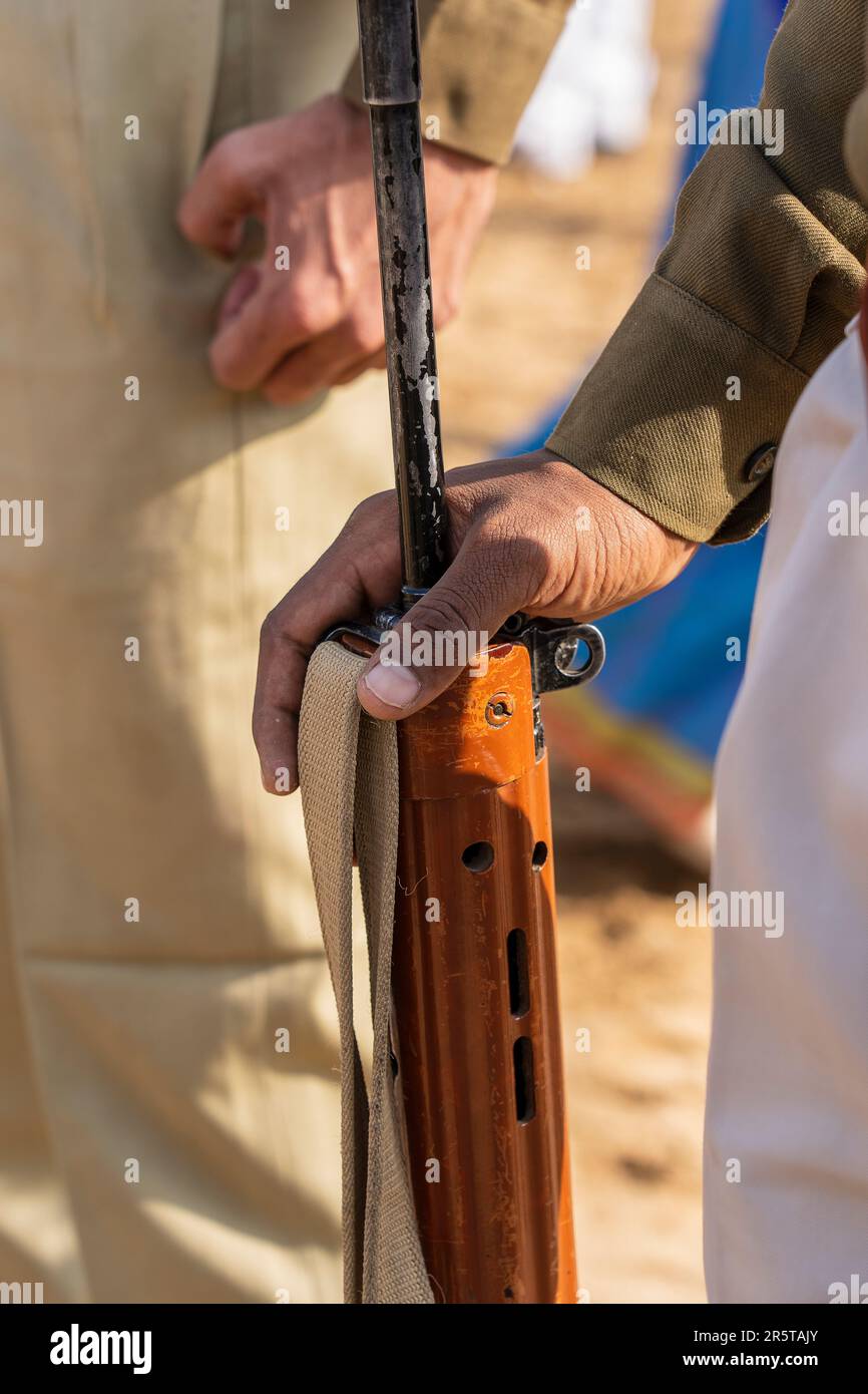Indian soldier standing with weapon in hand, India, close up Stock ...