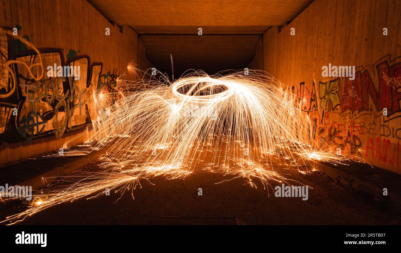 A vibrant light trails behind a moving source of illumination, with ...