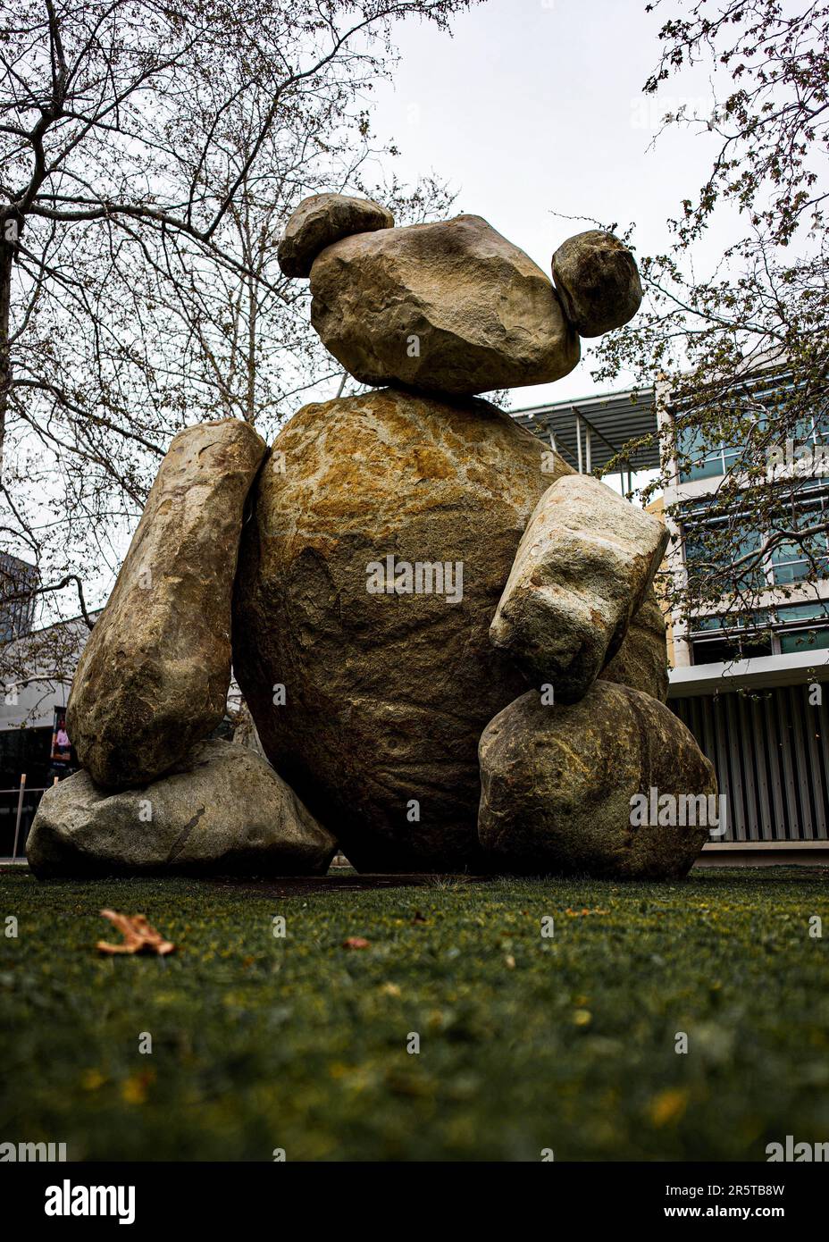 A rock sculpture of a teddy bear, surrounded by a lush landscape Stock ...