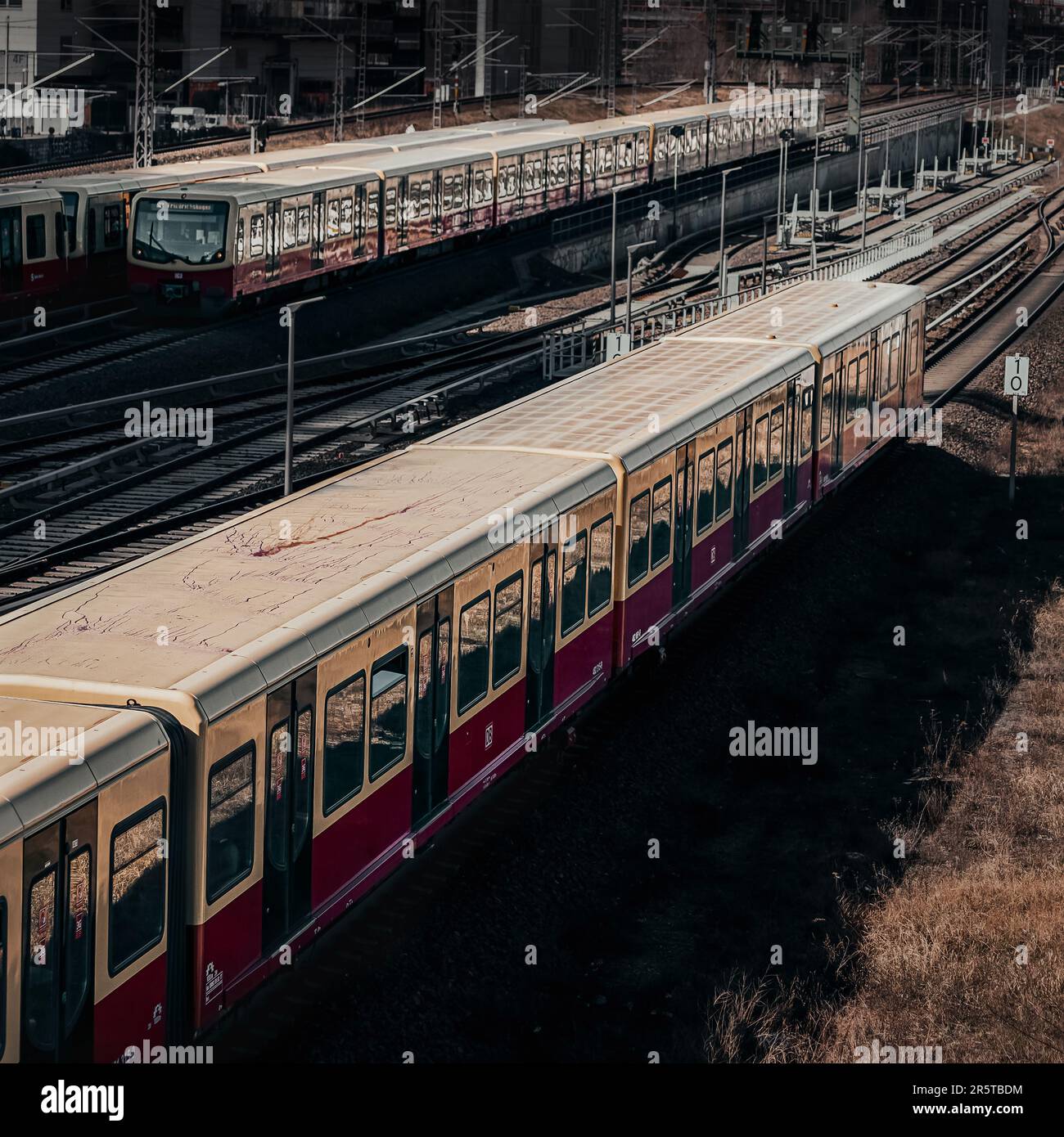A picture of a railway station during the day, with multiple trains ...