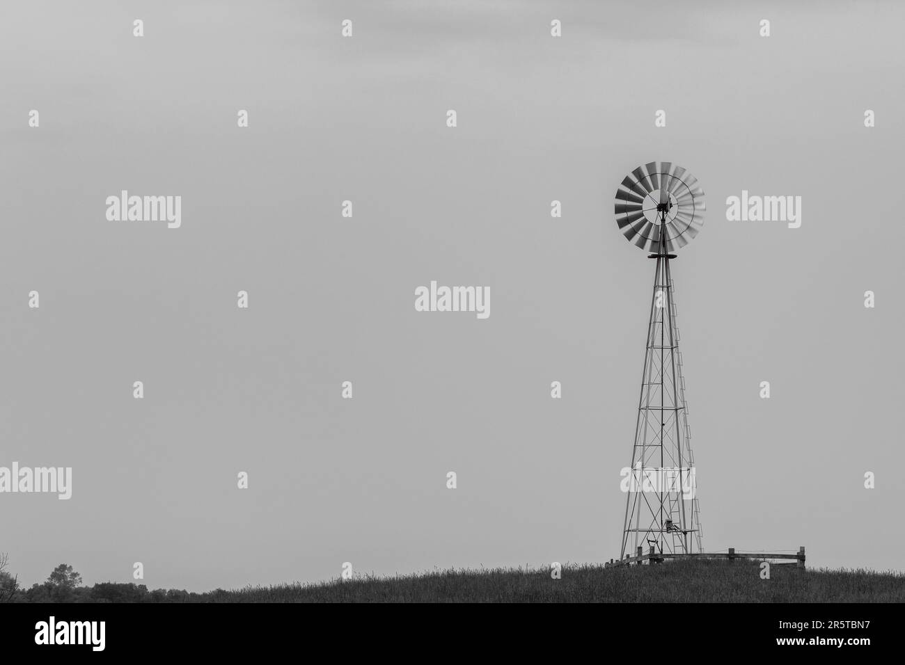 A solitary windmill stands tall against a overcast sky in rural Ohio's Amish Country in the ...