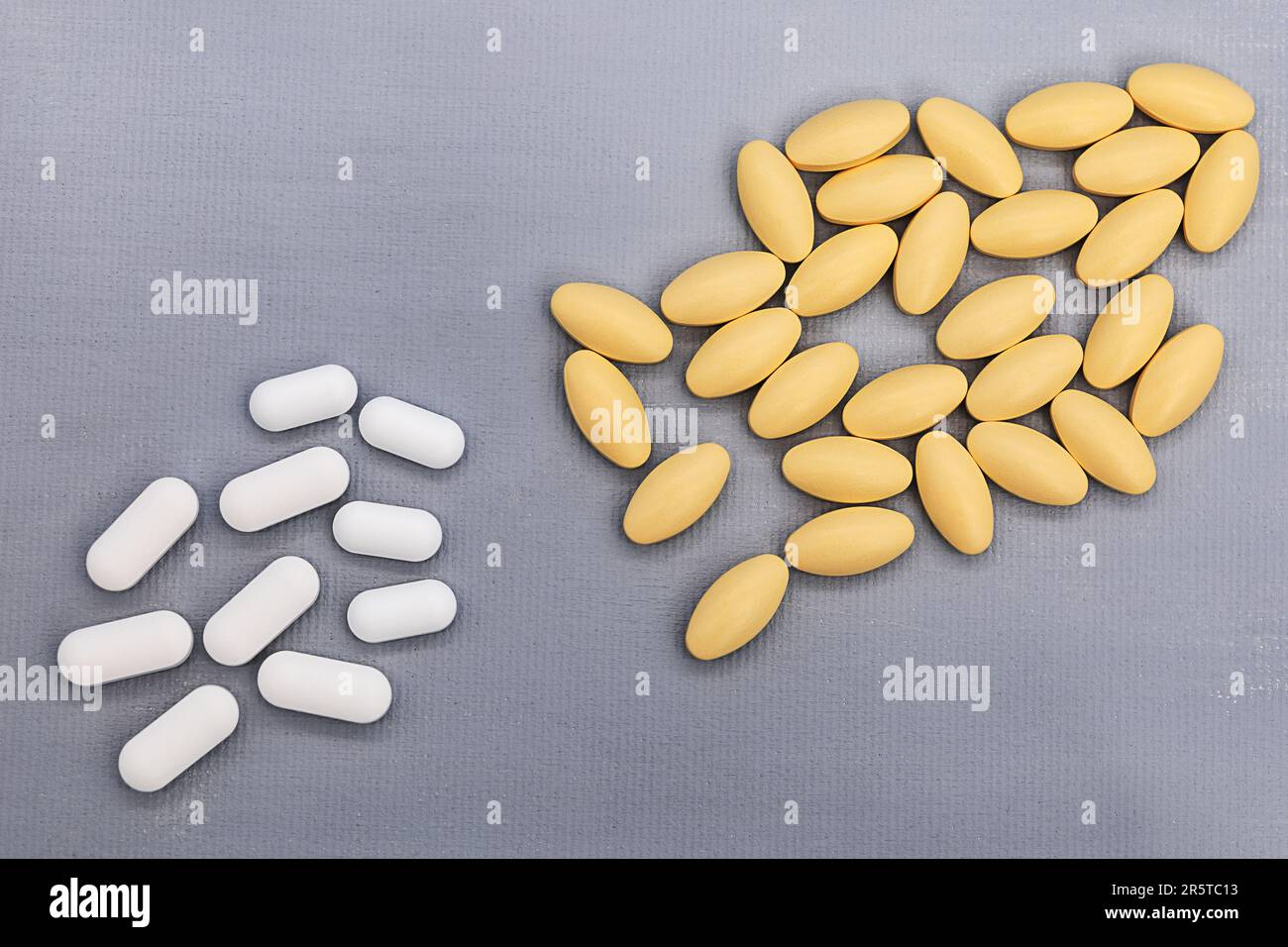 oval-shaped tablets lie on a contrasting background Stock Photo - Alamy