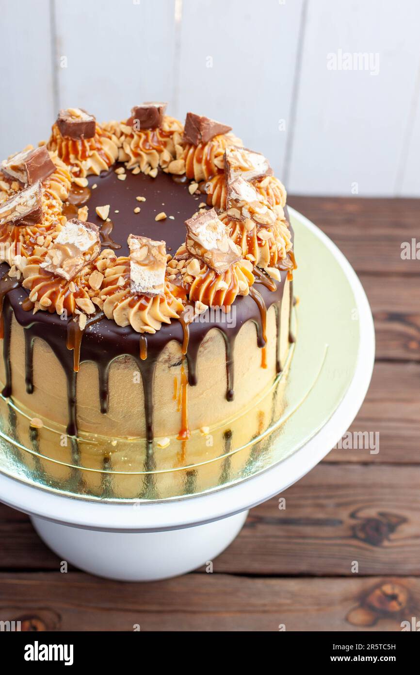Gorgeous snickers cake with peanut butter cream, melted chocolate ...