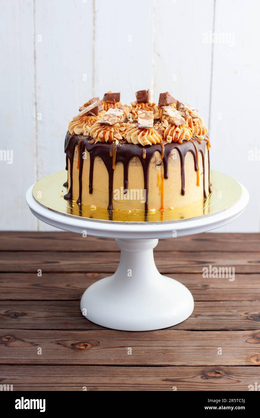Gorgeous snickers cake with peanut butter cream, melted chocolate ...