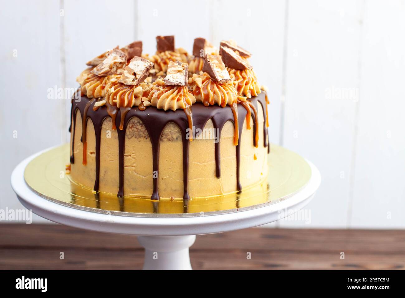 Gorgeous snickers cake with peanut butter cream, melted chocolate ...