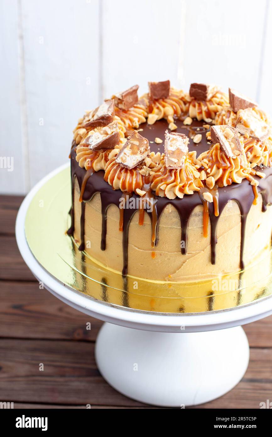 Gorgeous snickers cake with peanut butter cream, melted chocolate ...