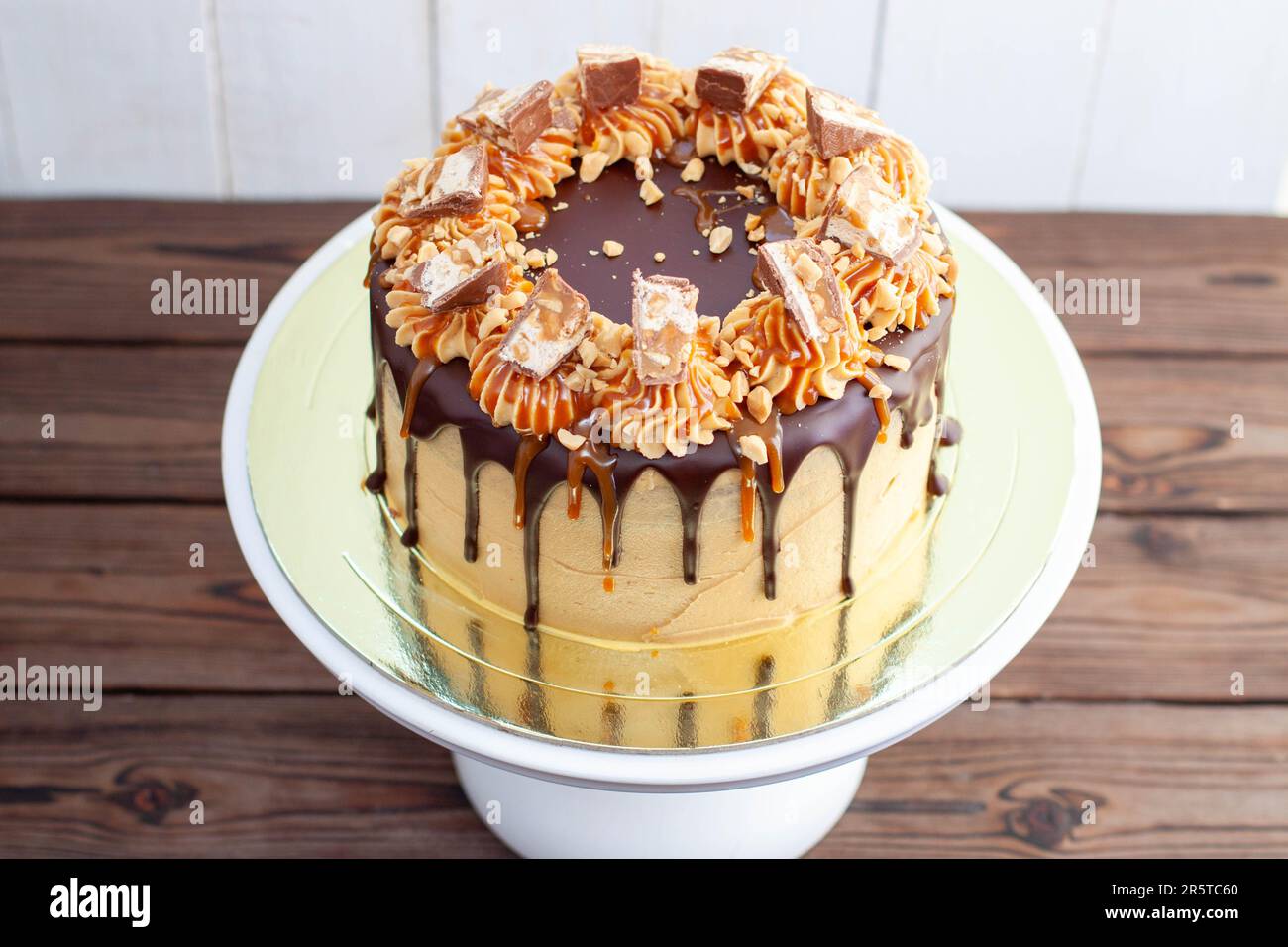 Gorgeous snickers cake with peanut butter cream, melted chocolate ...
