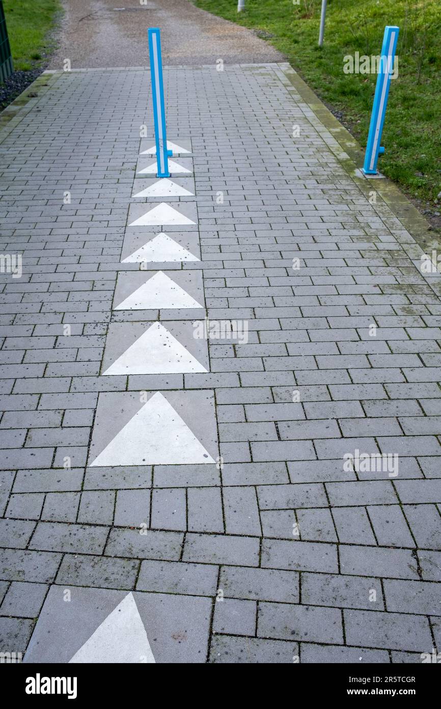 A road with a yellow arrow drawn on the ground highlighted with white ...