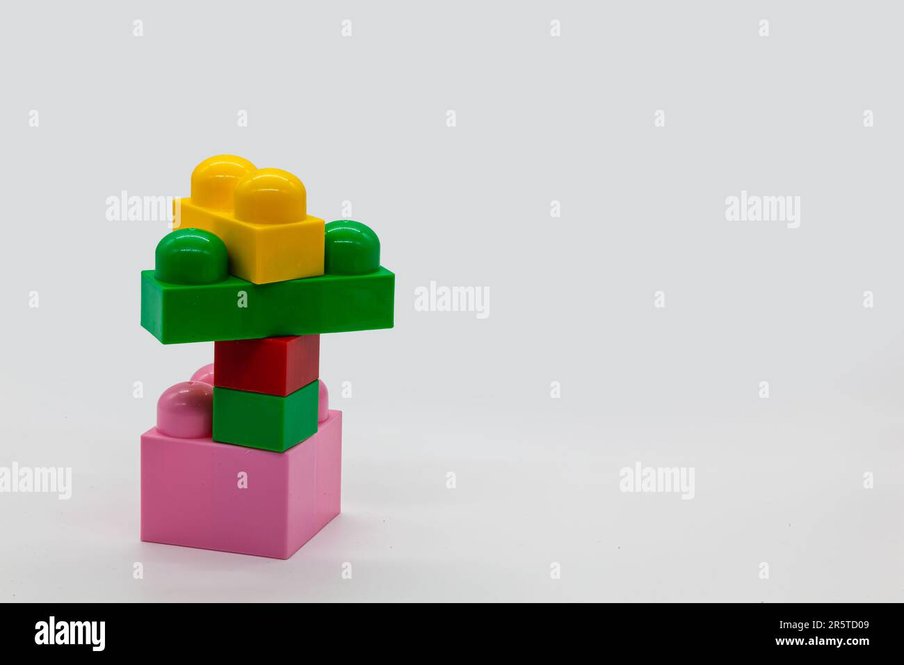 Children's toy constructor lego different sizes. Red, pink and yellow ...