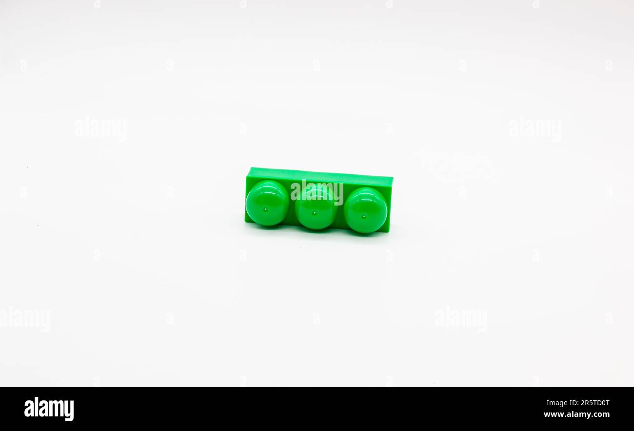 Children's toy construction set lego green color. Detail of three ...