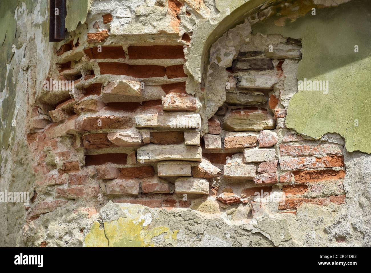 Background of old yellow brick wall with collapsed plaster. Texture of ...