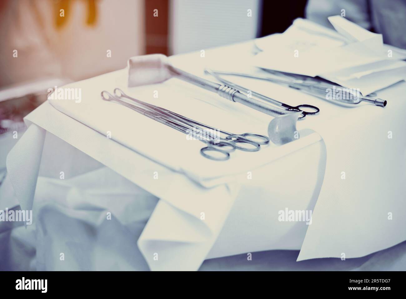 A selection of sharp medical tools on a colored fabric background Stock ...