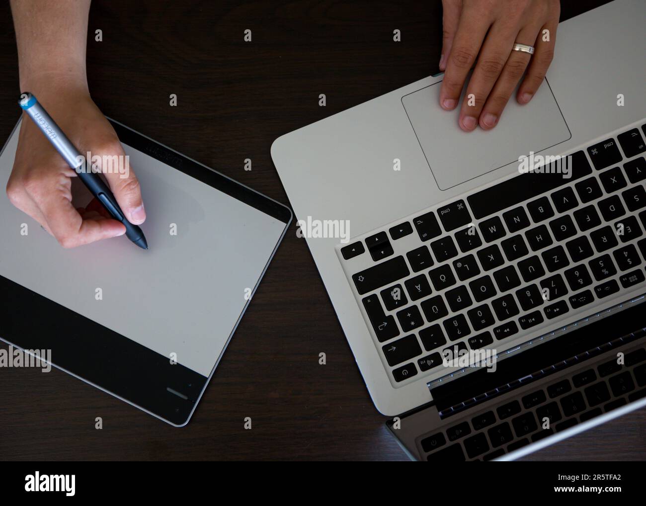 An office desk with connected electronic devices, a laptop computer and ...