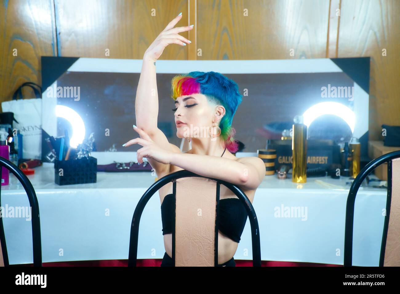 A young female model with multi-colored hair poses for the camera in a ...