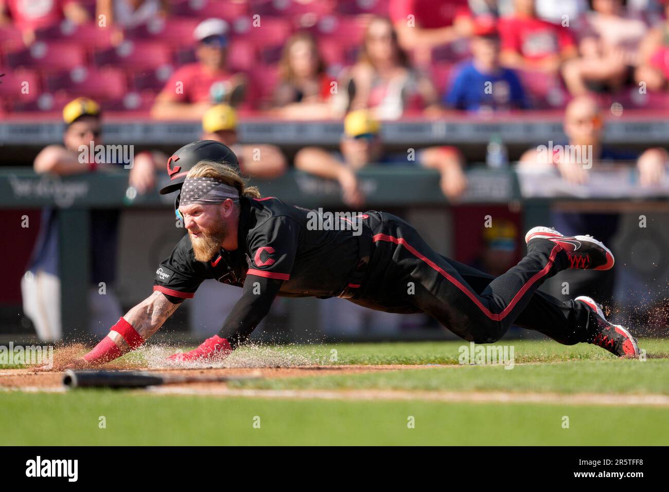 Cincinnati Reds' Jake Fraley scores a run during a baseball game ...