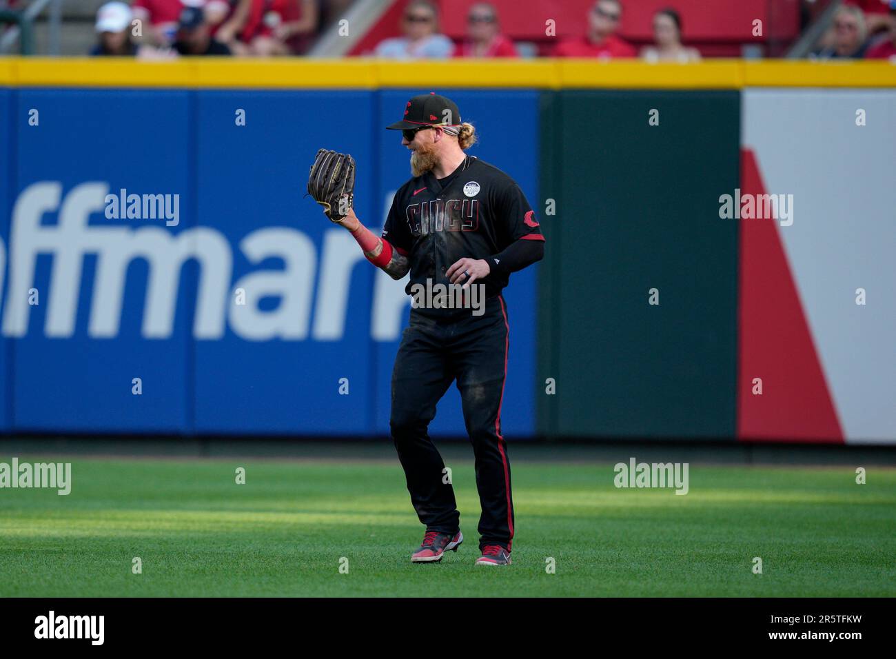 Cincinnati Reds left fielder Jake Fraley looks at his glove after ...