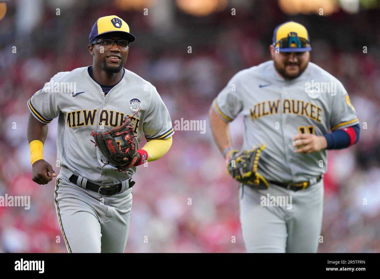 Milwaukee Brewers' Andruw Monasterio, left, and Rowdy Tellez (11) jog ...
