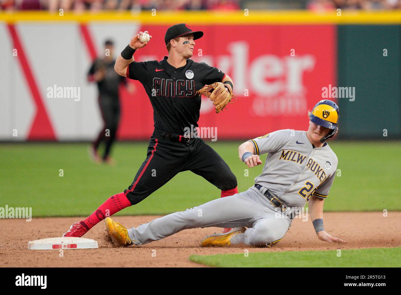 Cincinnati Reds shortstop Matt McLain turns a double play against ...
