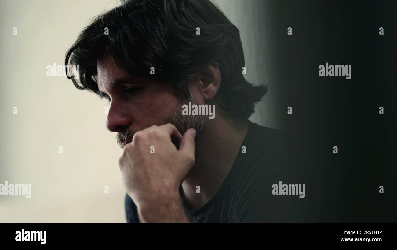 Worried young man mentally stuck in stress and anxiety. Preoccupied ...