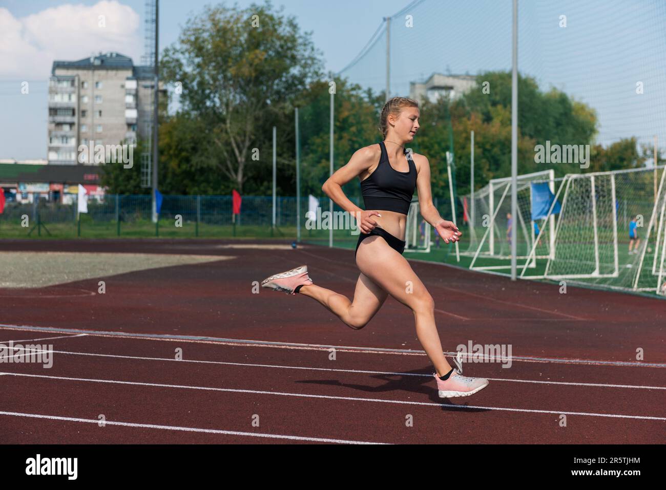 Young girl running on the running track at the stadium outdoors Stock ...